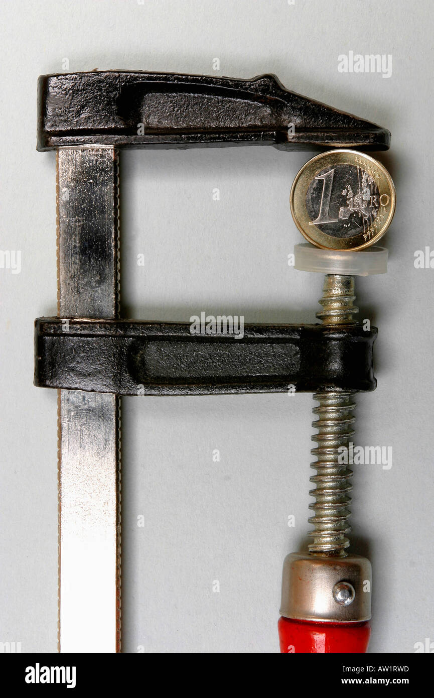 Euro in vice, coin Stock Photo - Alamy