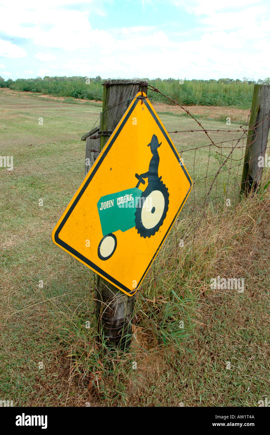 Tractor and a driver on the real farm sign in rural america in the ...