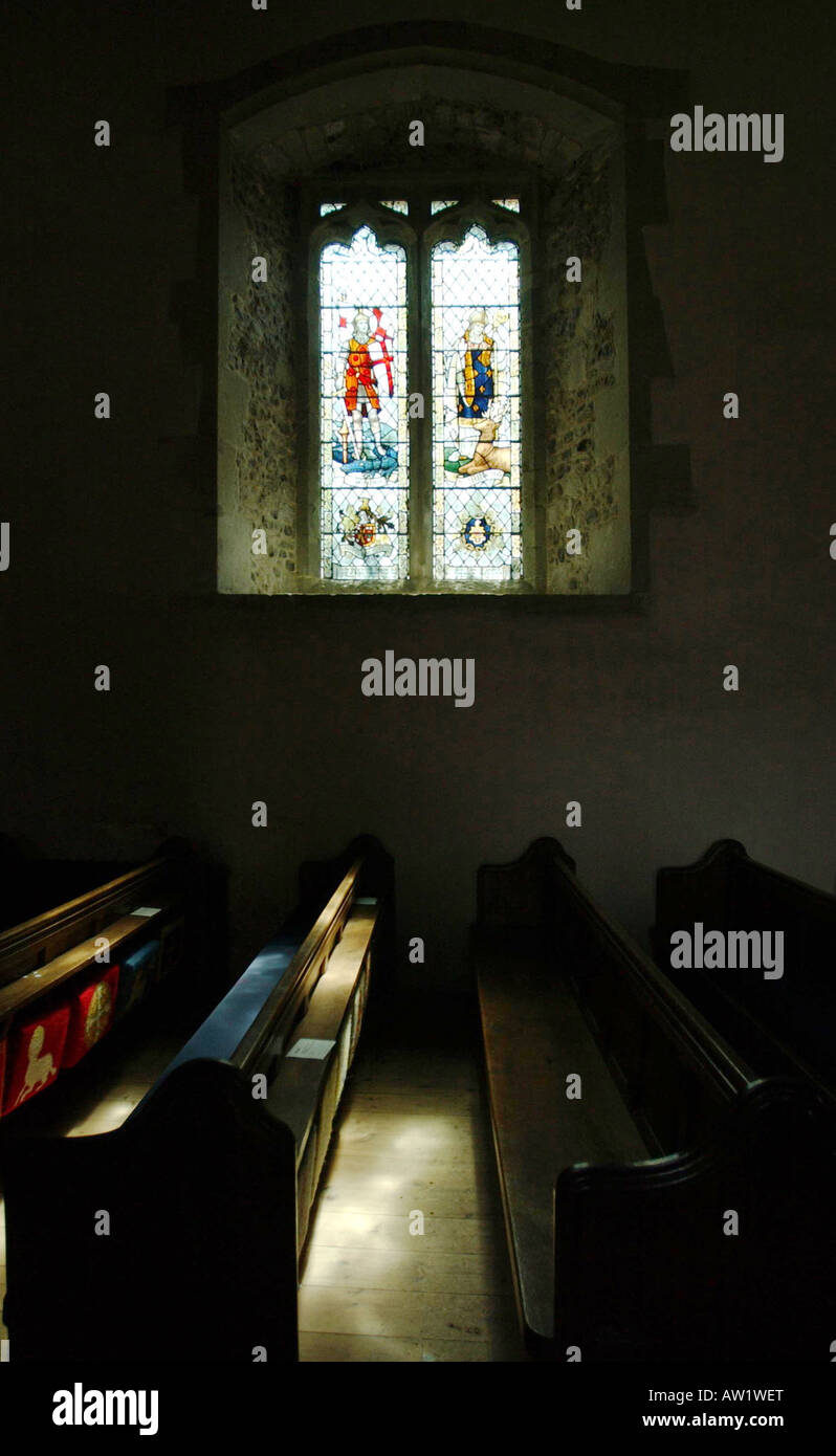Light streams through a humble stained glass arch window in a Norman ...