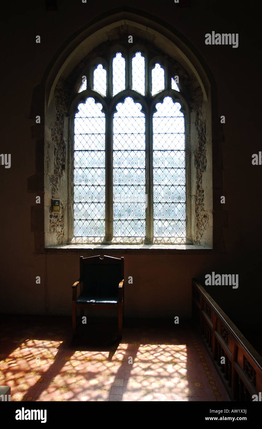 Light streams through a humble stained glass arch window in a Norman ...