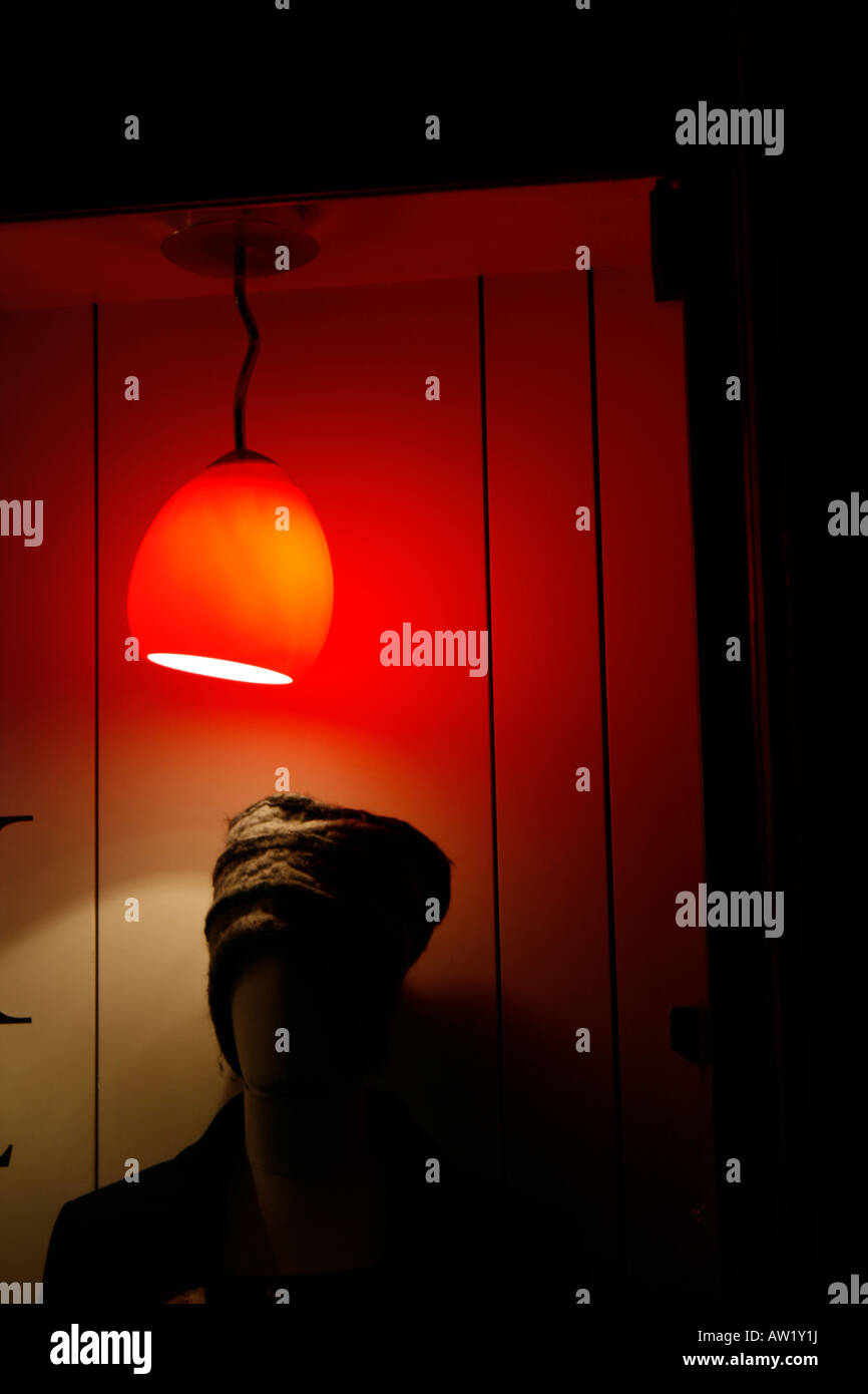 red light fitting and mannequin in shop window Stock Photo - Alamy