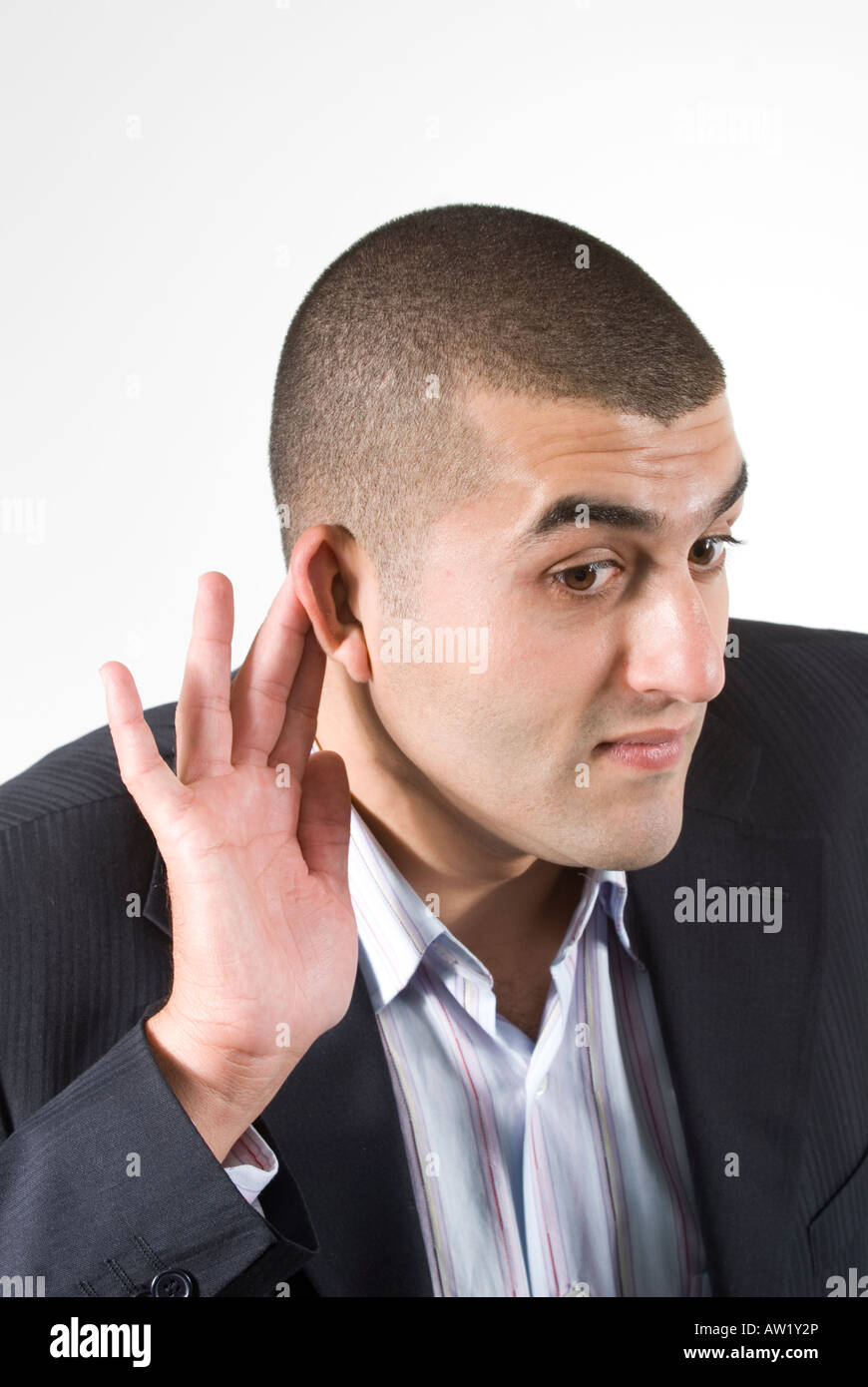 Man listening hand behind his ear Stock Photo - Alamy