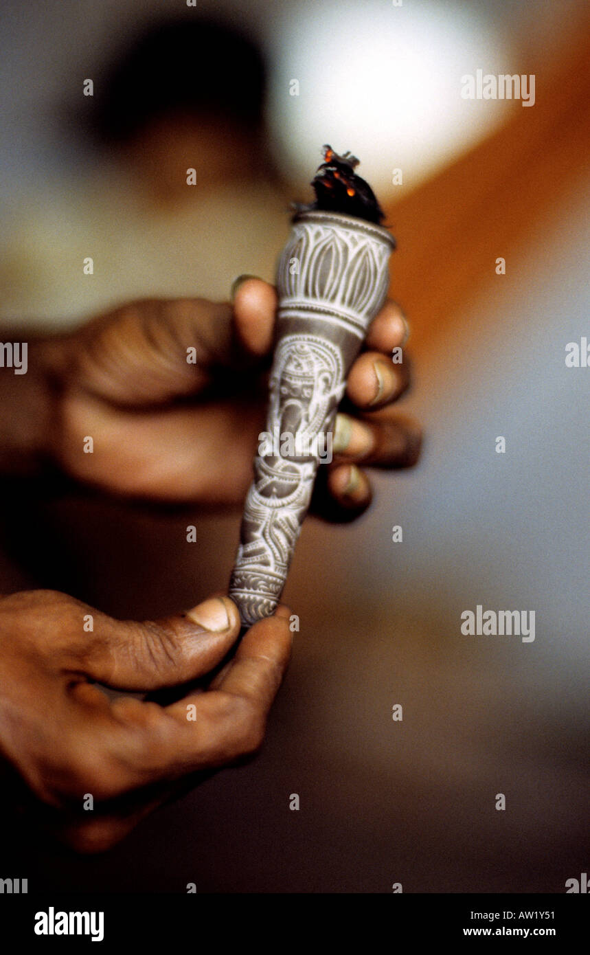 Baba, an Indian holy man, smoking grass with the traditional cilum pipe ...