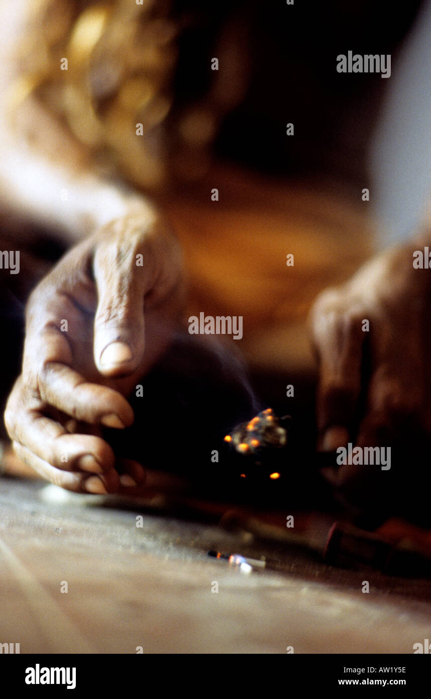 Baba, an Indian holy man, smoking grass with the traditional cilum pipe ...