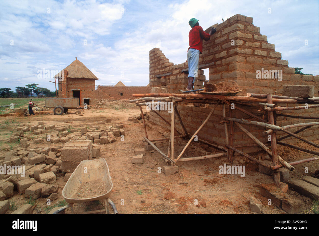 African man building small scale brick house on tobacco plantation in ...