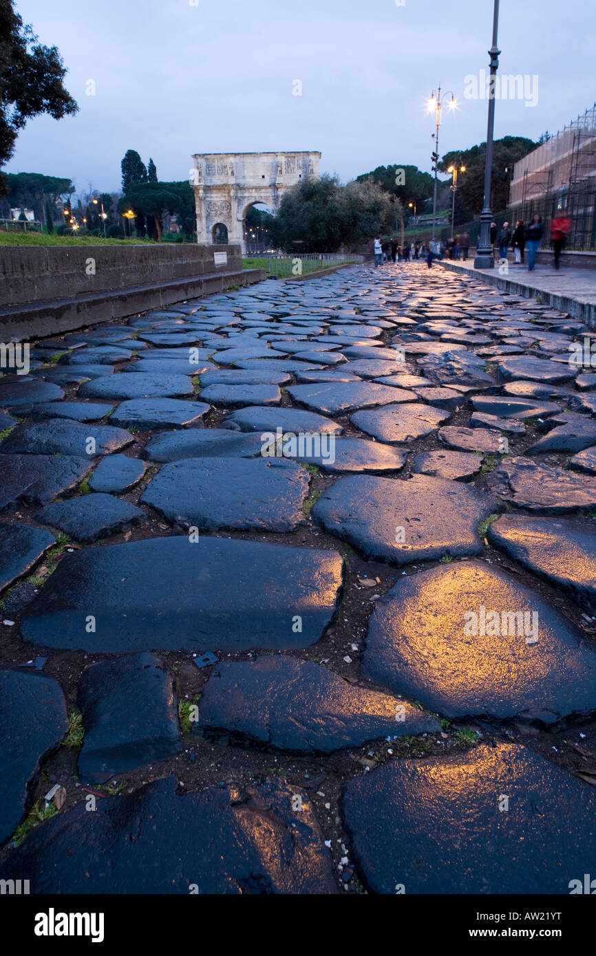 Roman street near the Colosseum and Arch of Constantine in background ...