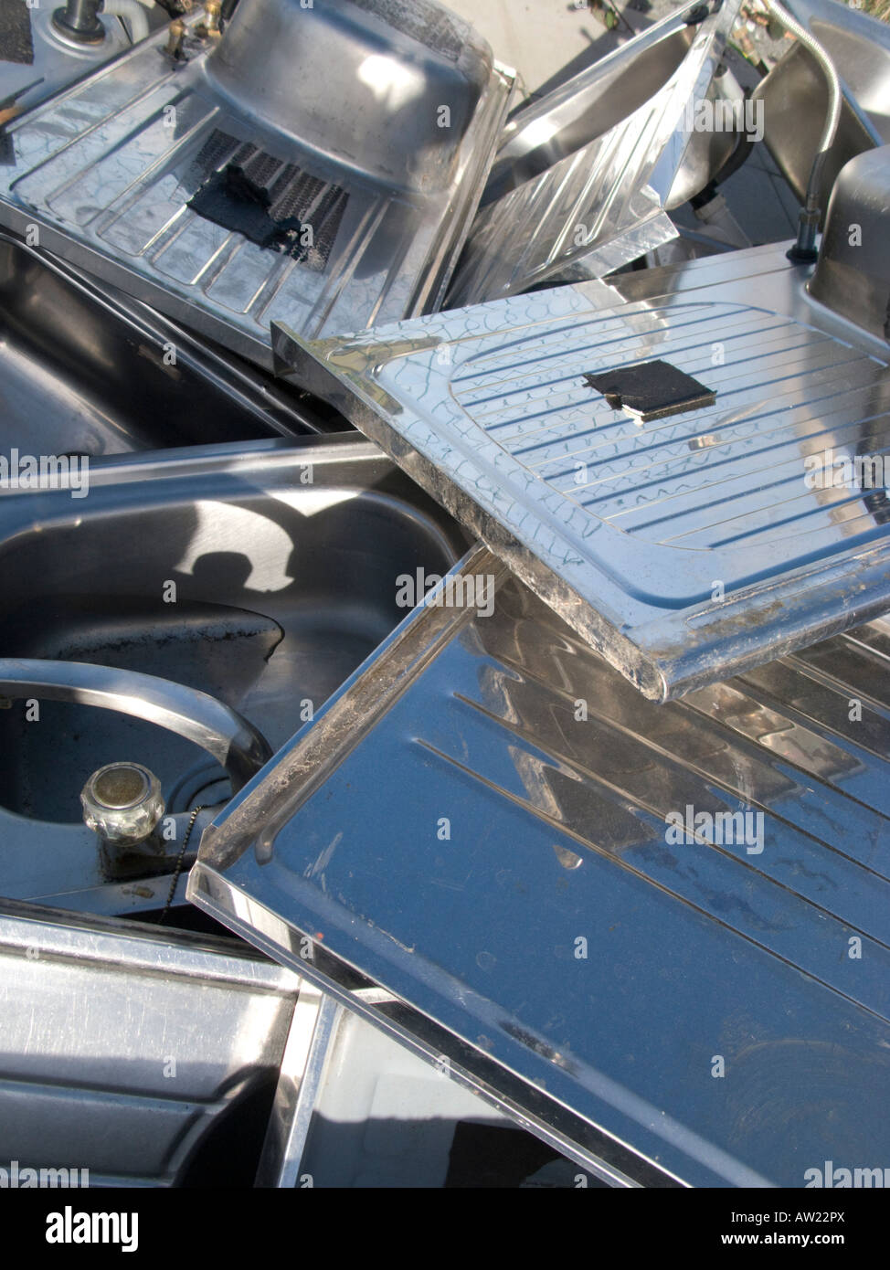Pile of old stainless steel kitchen sinks in recycling yard awaiting ...