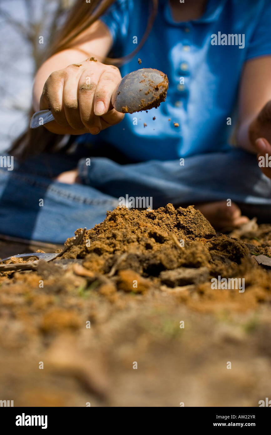 Playing in the dirt with spoon Stock Photo - Alamy
