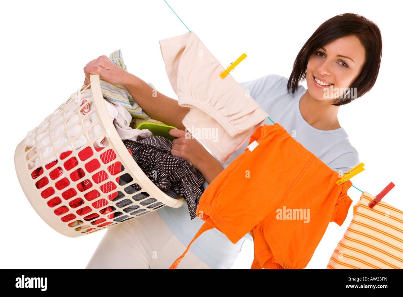 Young smiling woman hanging clothes on clothesline She holding clothes ...