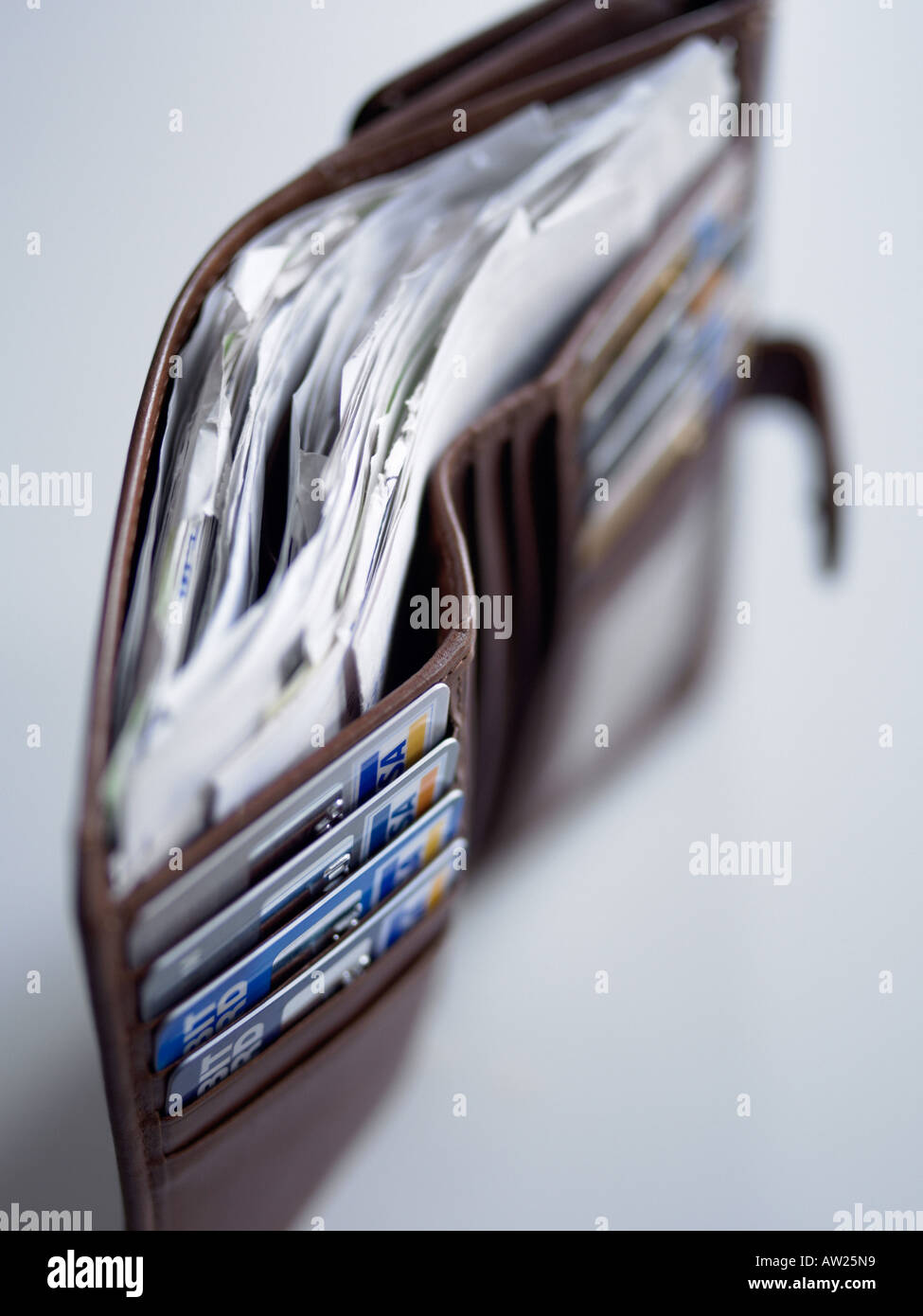 Wallet full of cards and receipts Stock Photo - Alamy