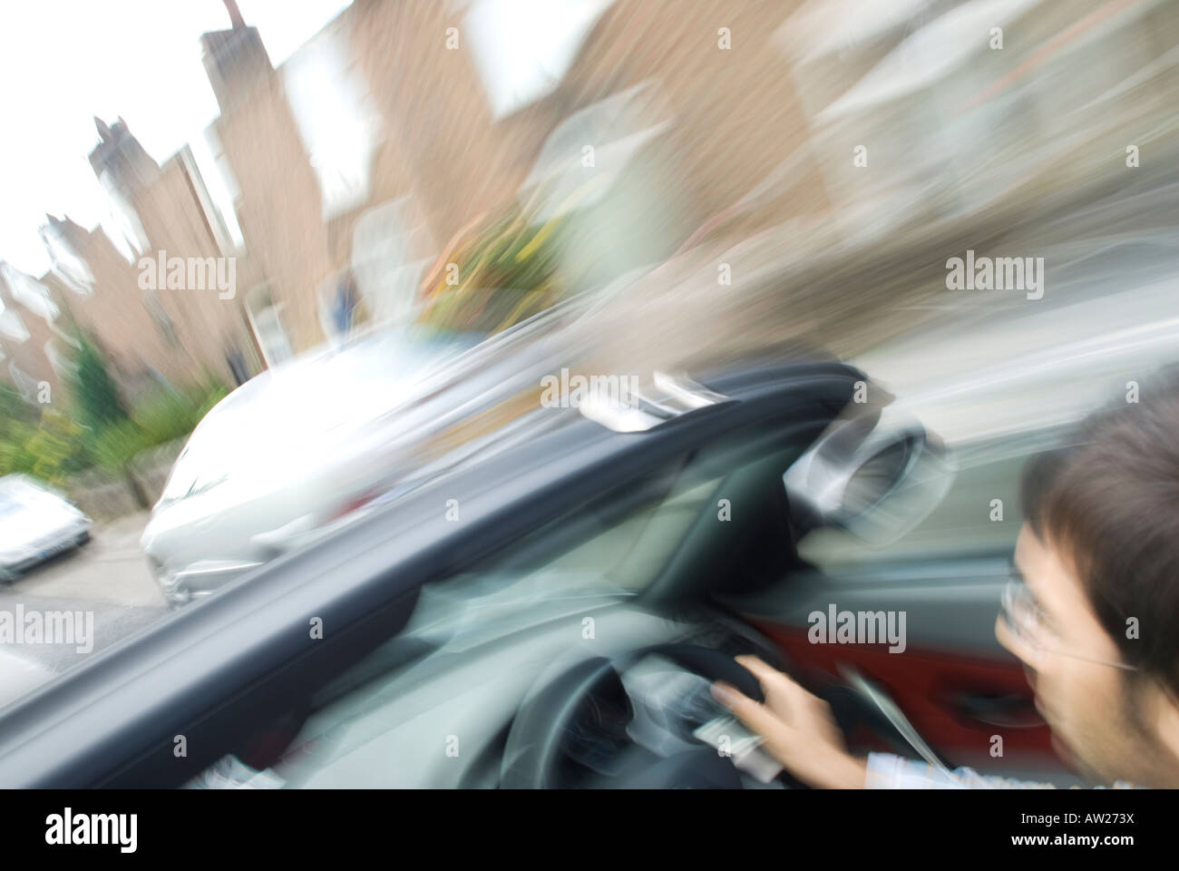 Man driving BMW Z4 through british street motion blur Cheshire 2007 ...