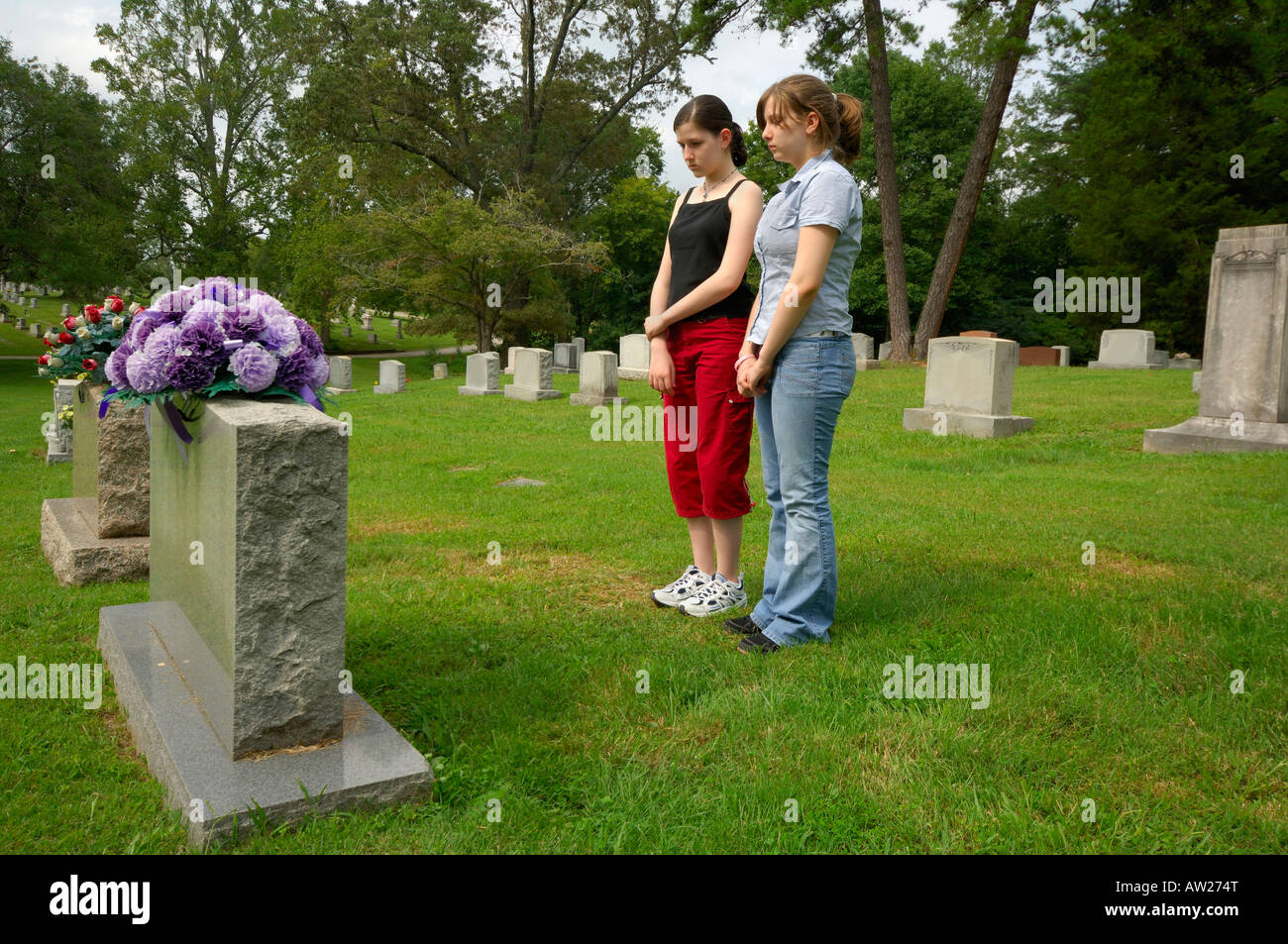 Teen girls mourn the loss of a family member. The young ladies gaze ...