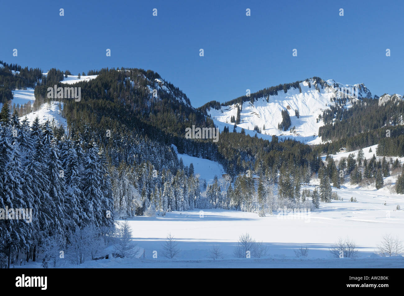 Frozen lake Spitzingsee with mountains Stuempfling left side and ...