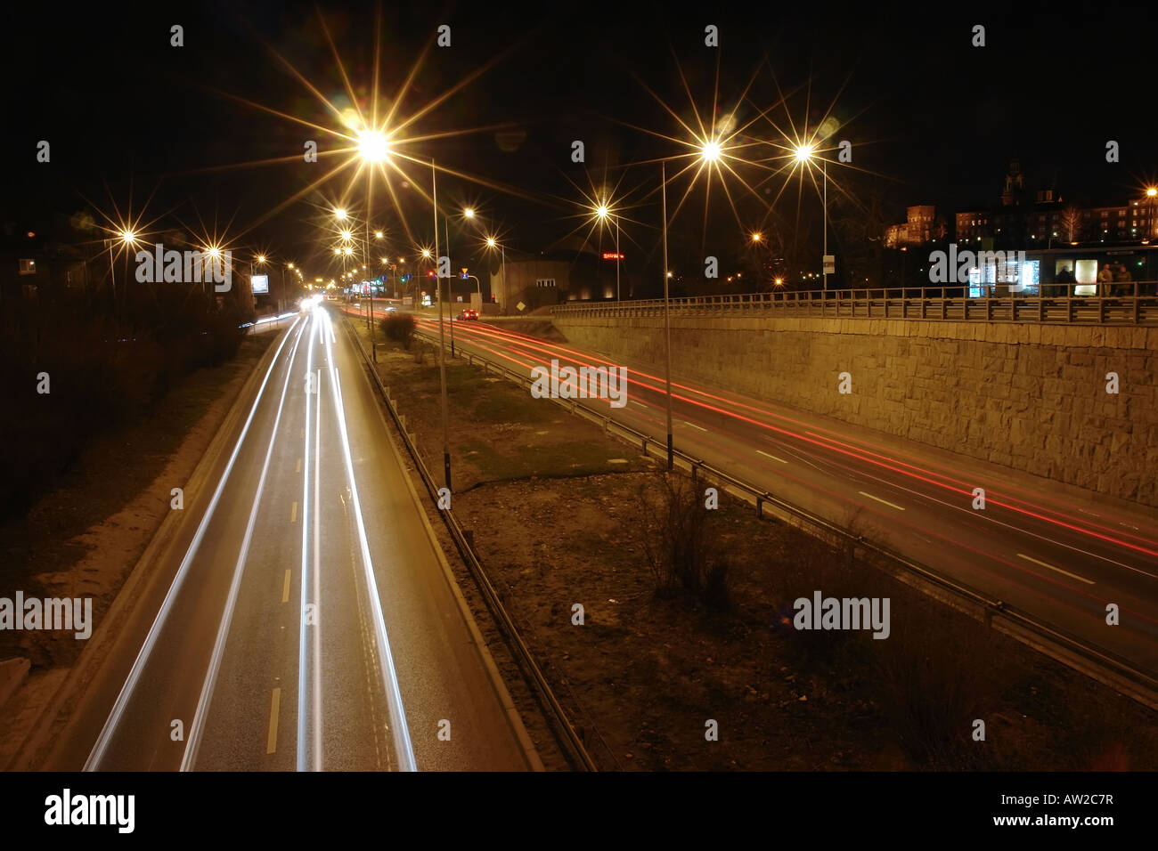 Night traffic light trails created by red rear and white headlights of ...