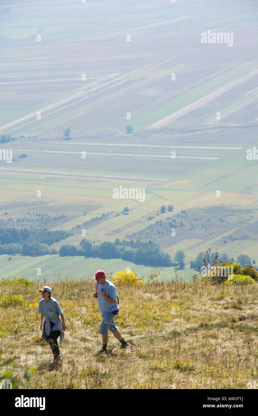 People hiking on Slivnica Hill by lake Cerknica in Slovenia in sunshine ...