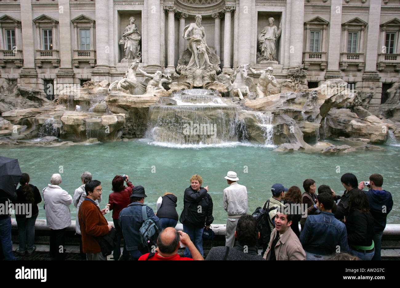 Female tourist throws a coin over her shoulder for good luck and to ...