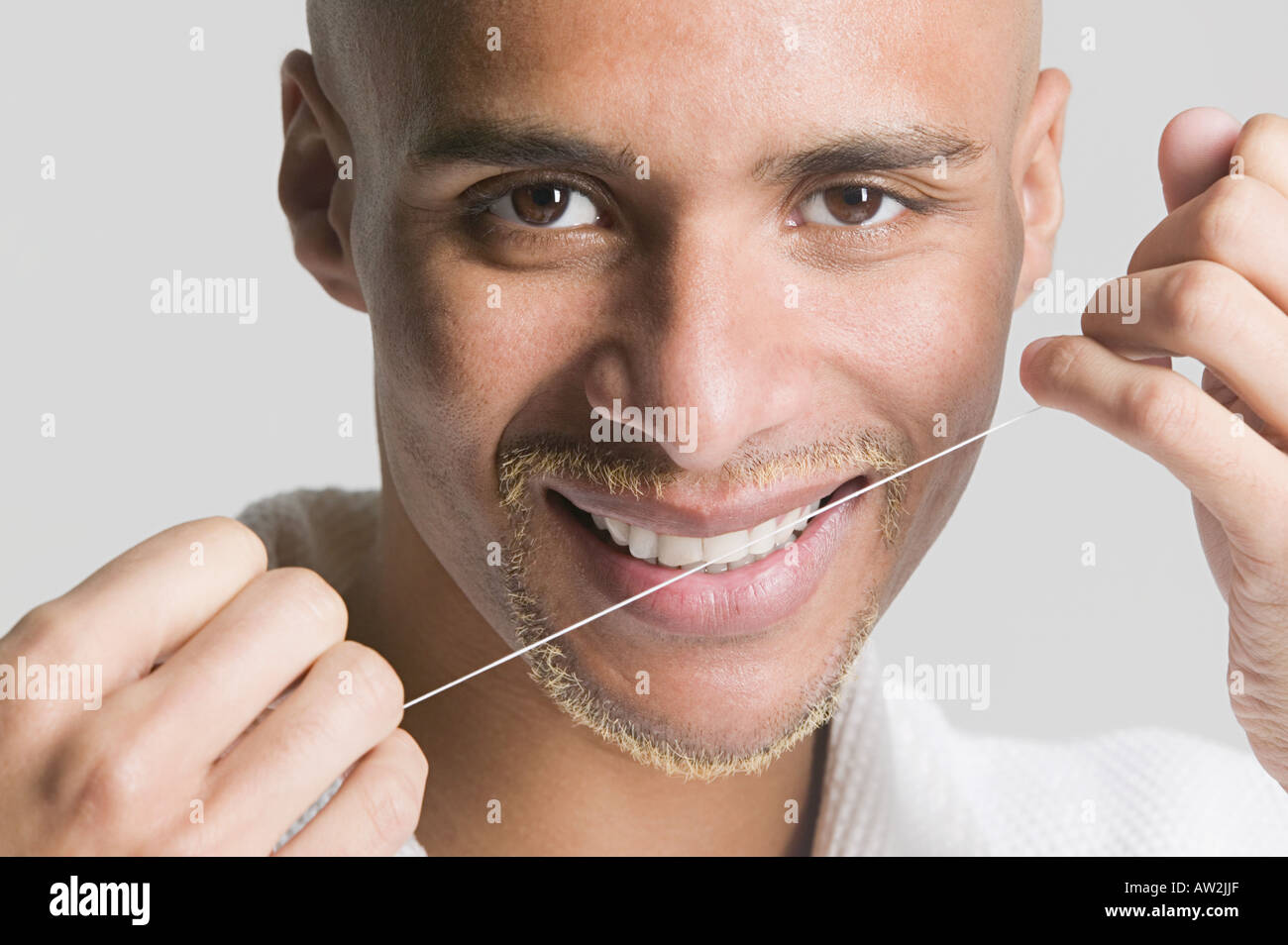 Man flossing his teeth Stock Photo - Alamy