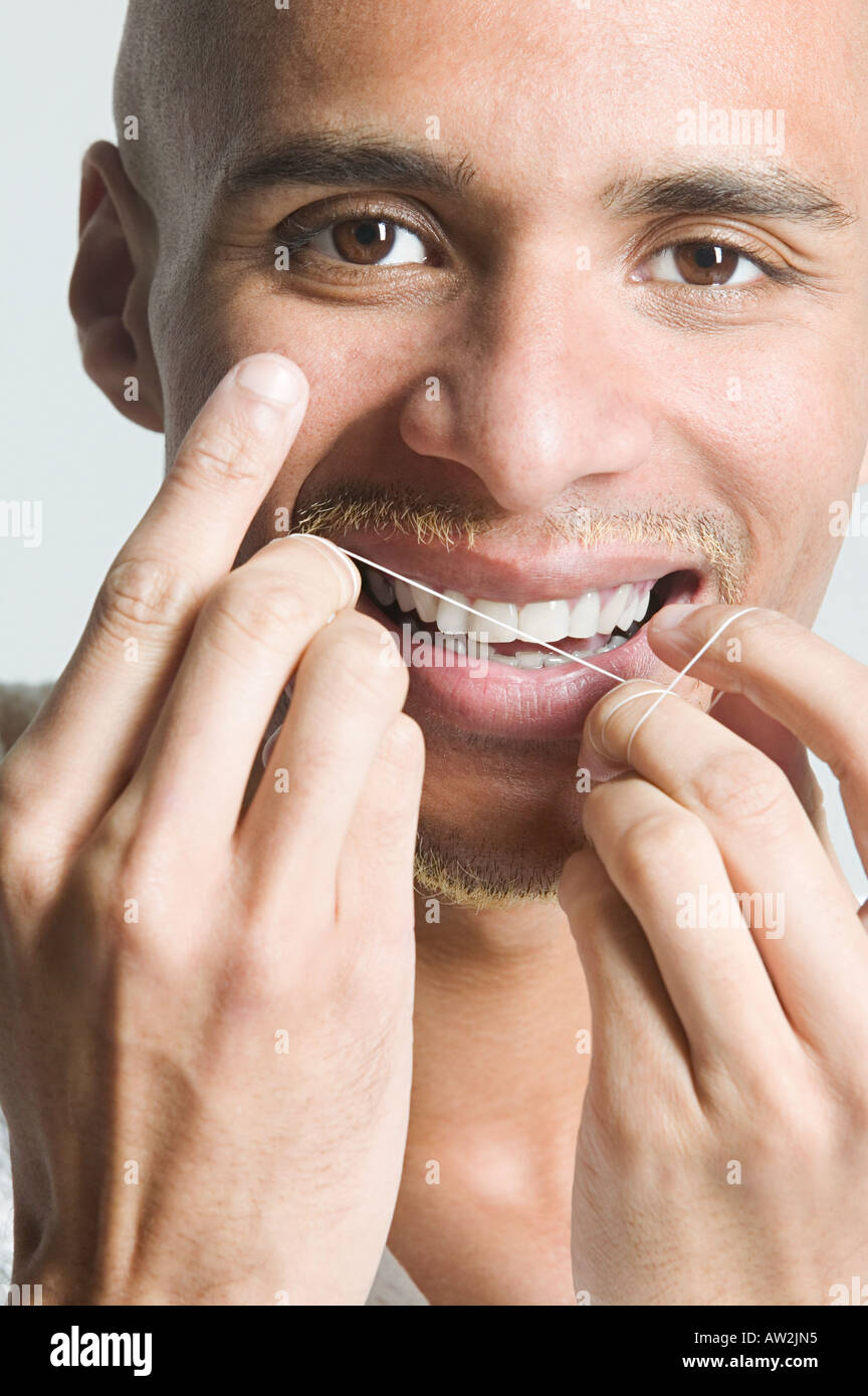 Man flossing his teeth Stock Photo - Alamy