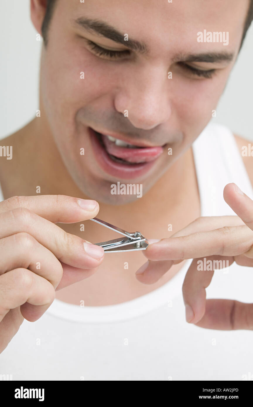 Man clipping his finger nails Stock Photo - Alamy