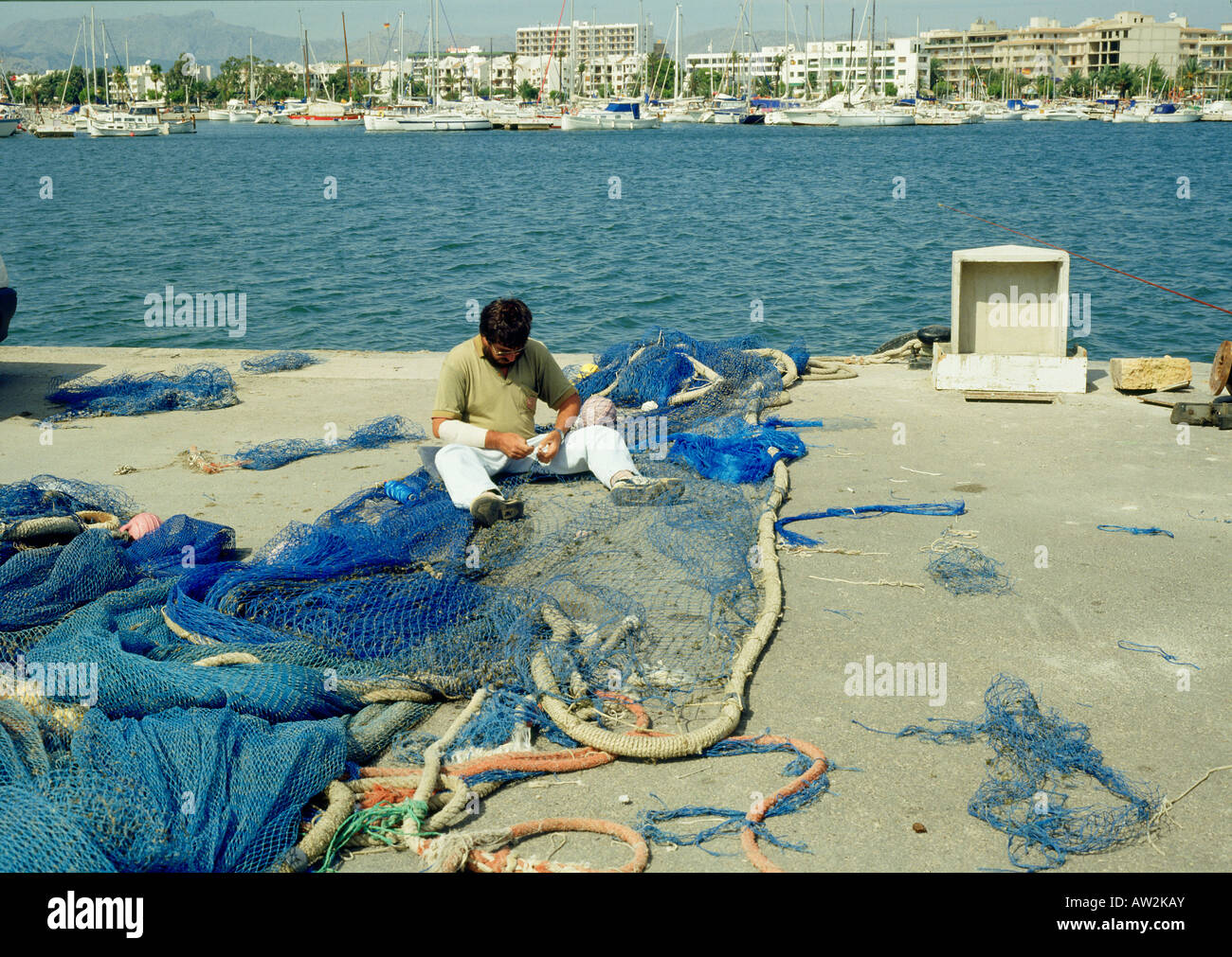 fixing a net in majorca Stock Photo - Alamy