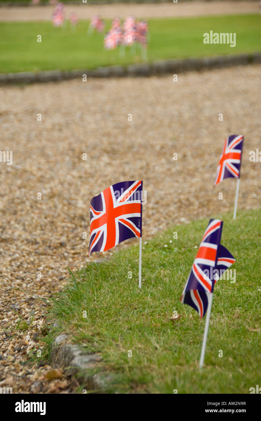 Union jack flags marking the path in an English garden at a summer ...