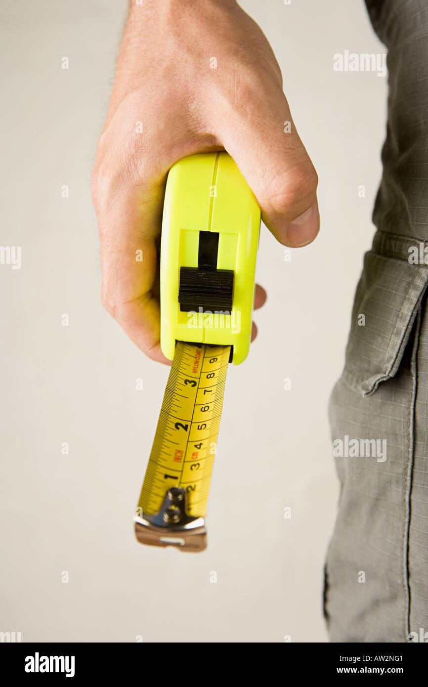 Person holding a tape measure Stock Photo - Alamy