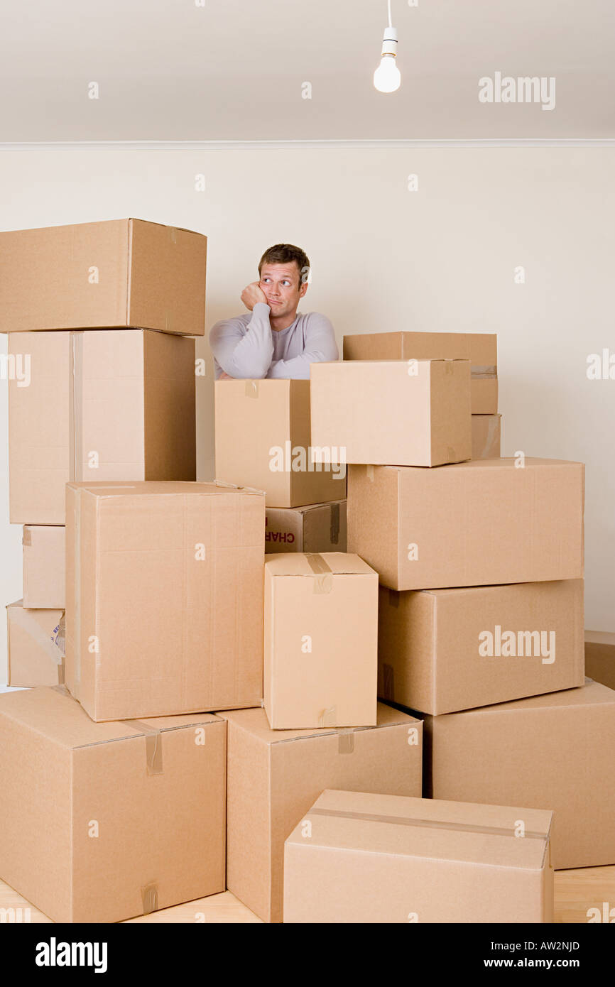 Man with stack of cardboard boxes Stock Photo - Alamy