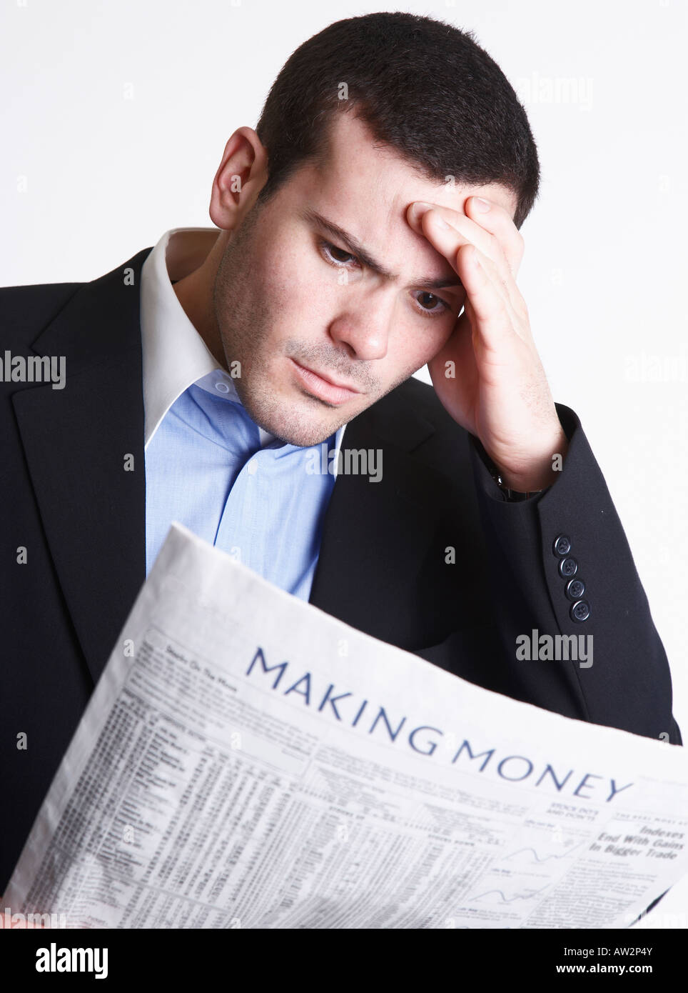 businessman reading financial page of newspaper, with his hand on his ...