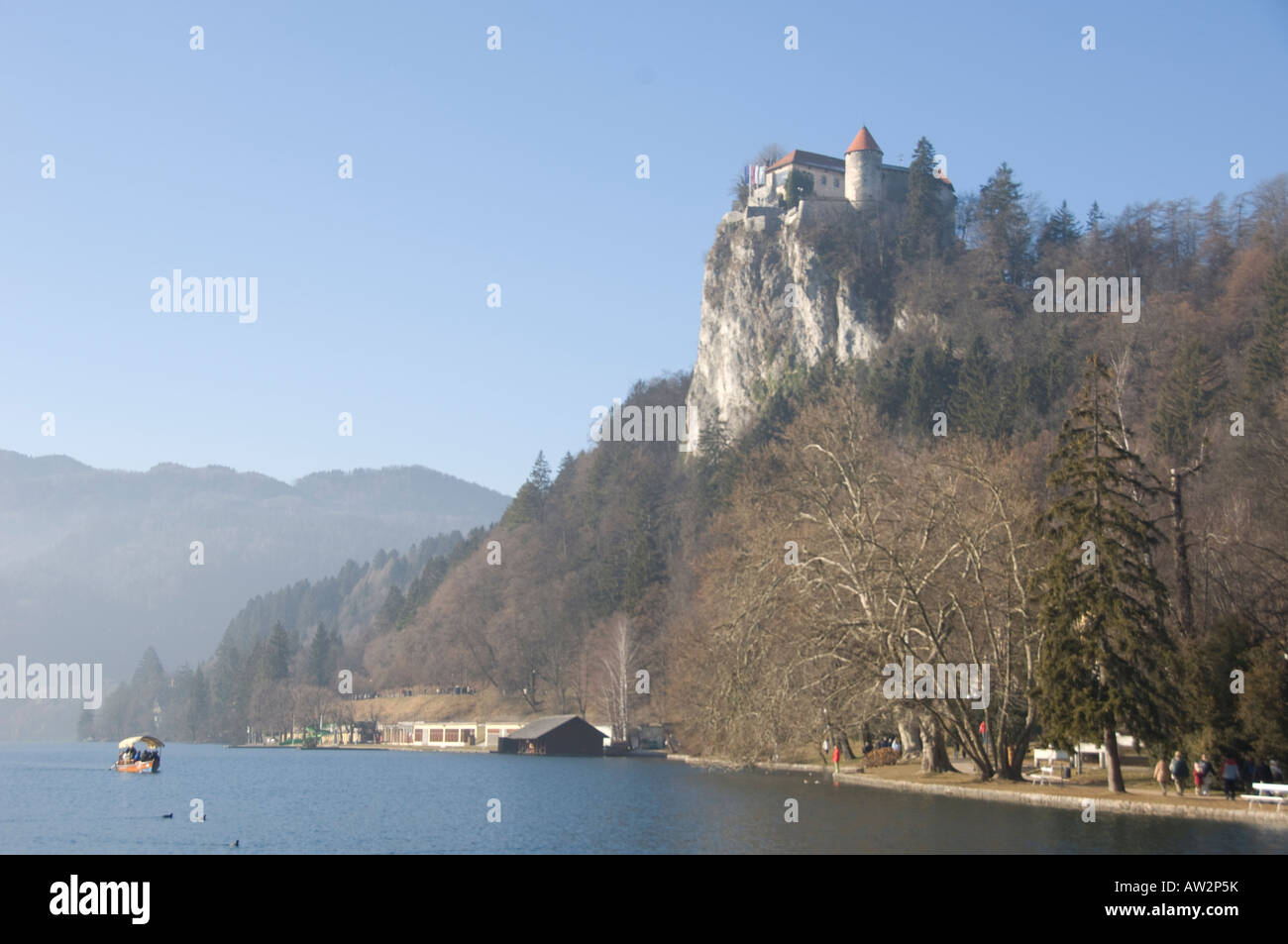 View of Bled Castle across Lake Bled, Slovenia, on a sunny winter day ...