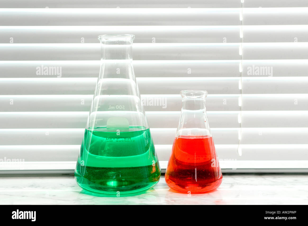two beakers on window sill Stock Photo - Alamy