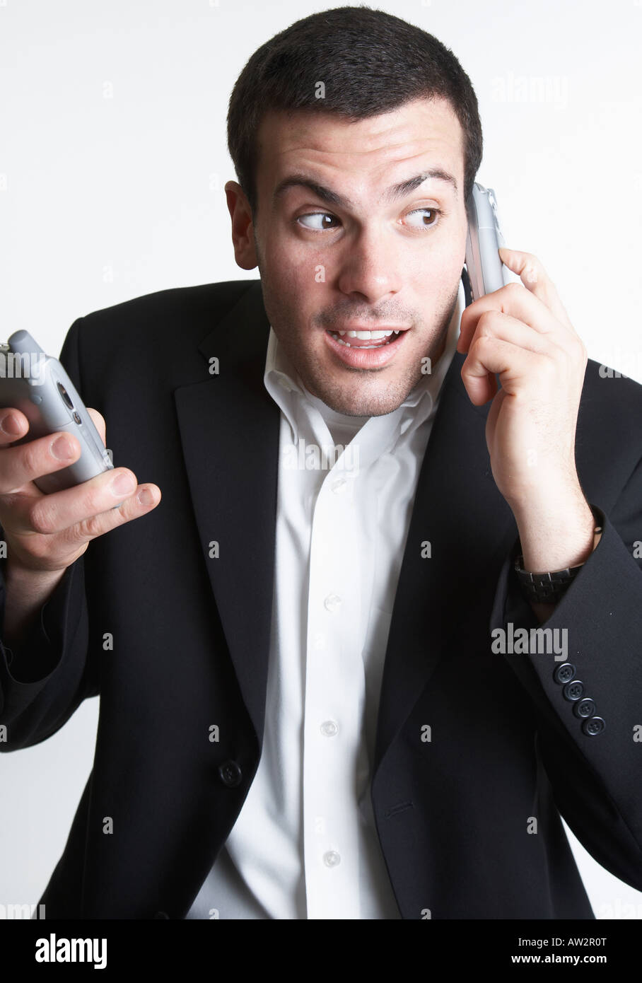 businessman with two wireless devices Stock Photo - Alamy