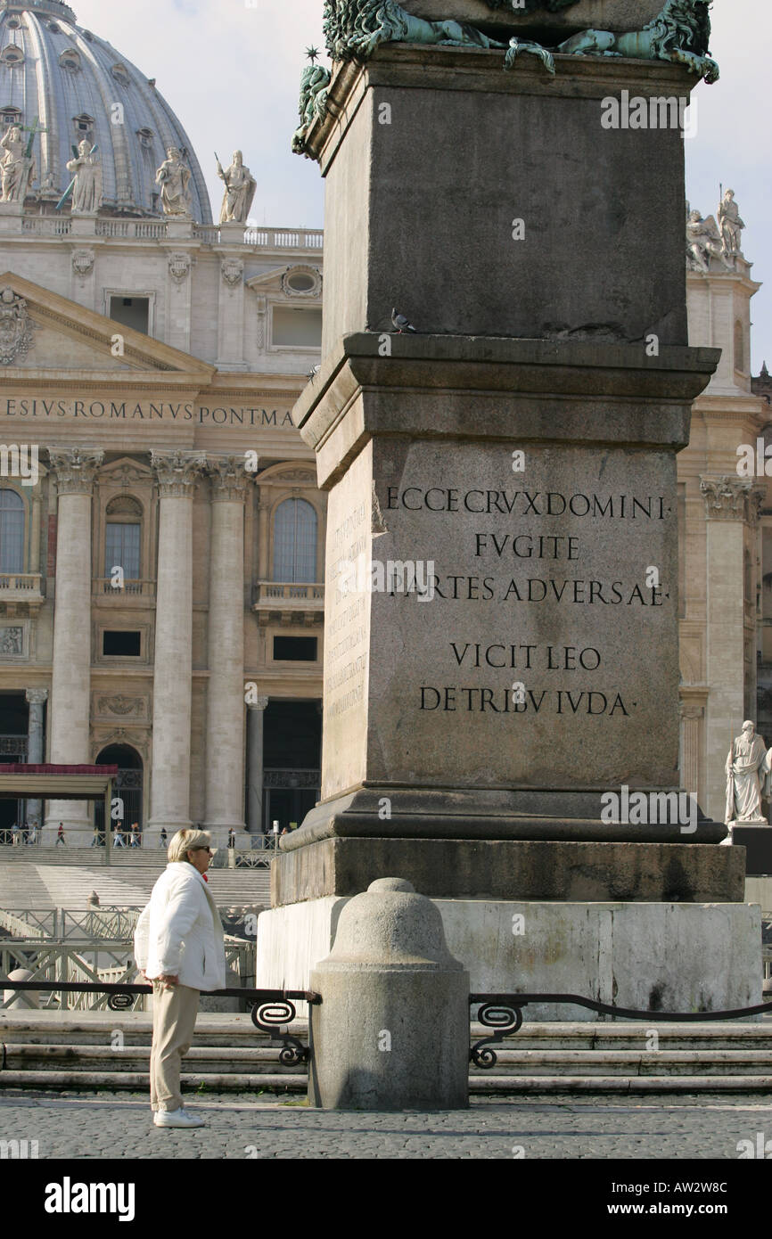 A lone tourists reads the Latin inscription on the Obelisk St Peters ...