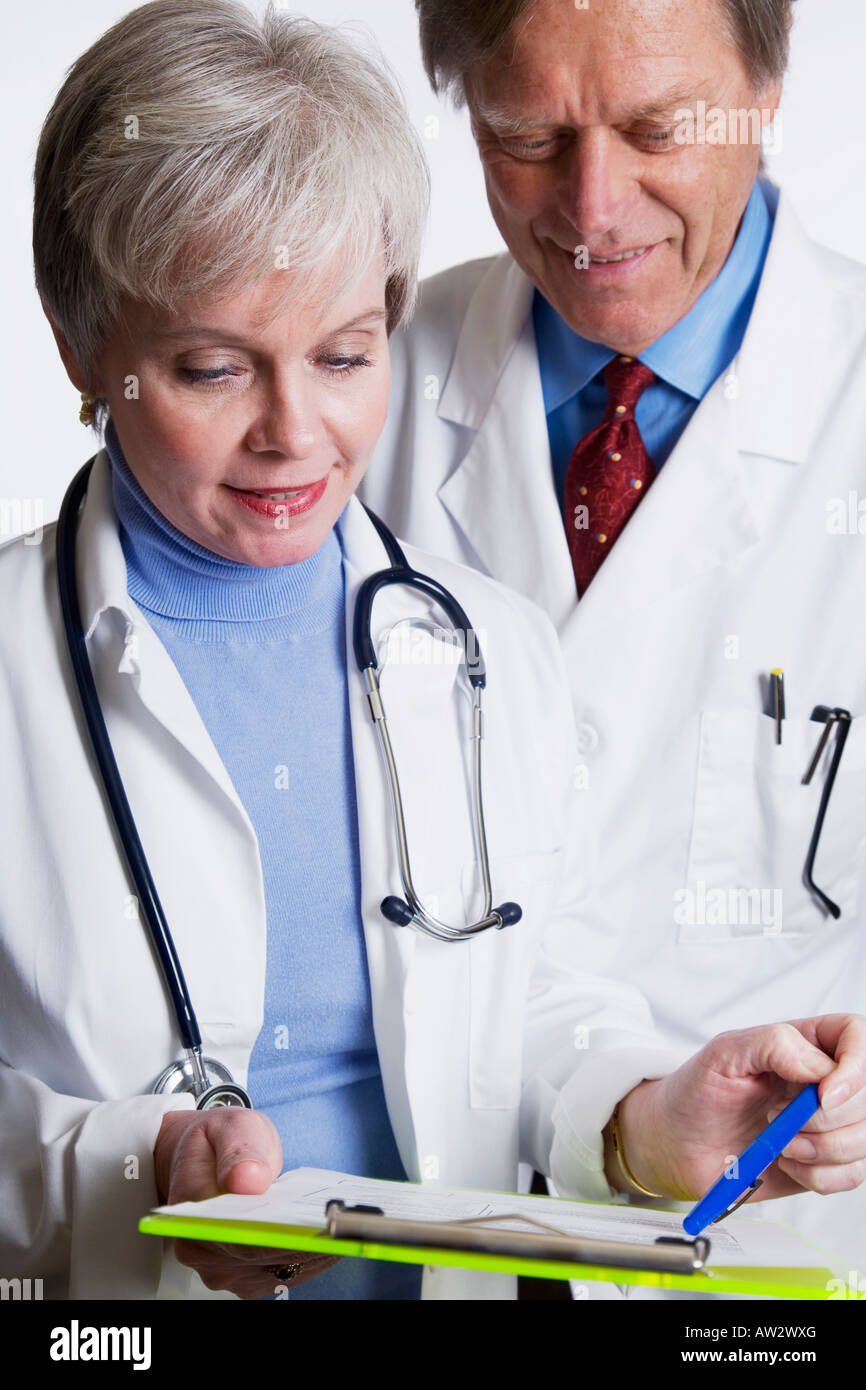 two senior doctors looking at medical chart Stock Photo - Alamy