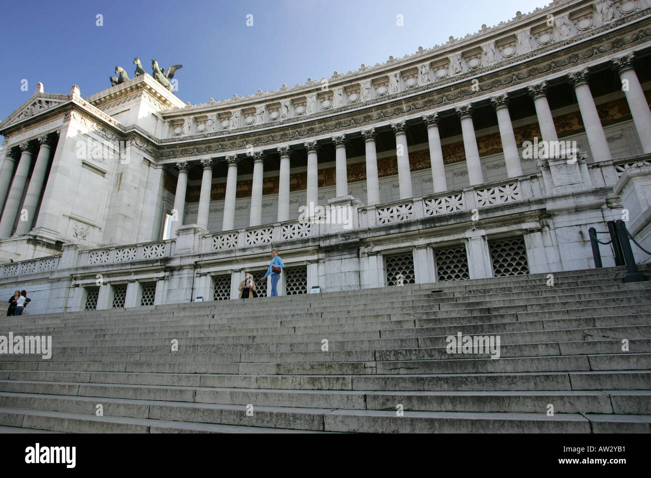 Tourists are dwarfed by massive white stone columns at the famous ...