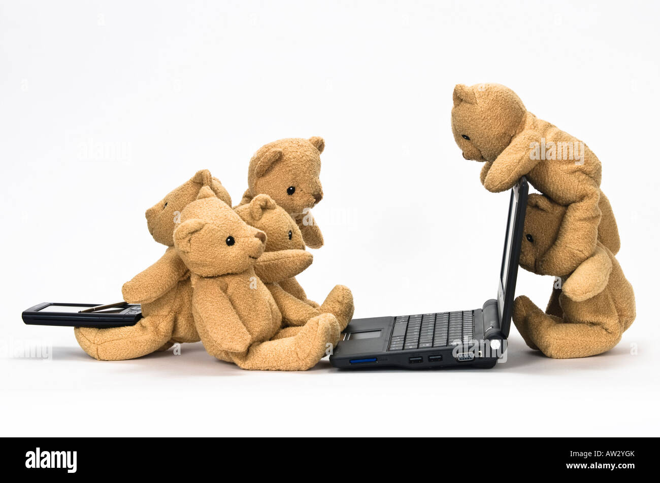 six soft toy stuffed brown bears working at a small laptop three from ...