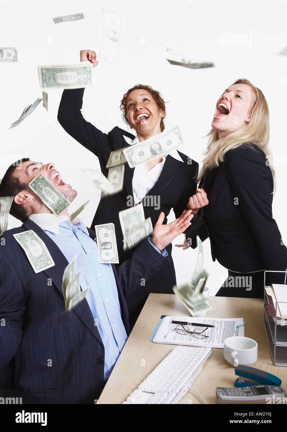 paper money falling from the sky on three business people in their ...