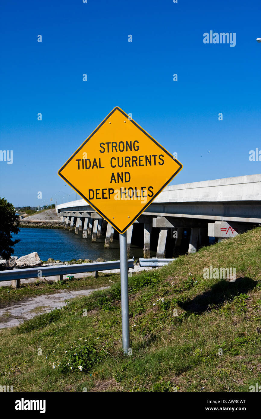 Caution sign strong tidal currents and deep holes Stock Photo - Alamy