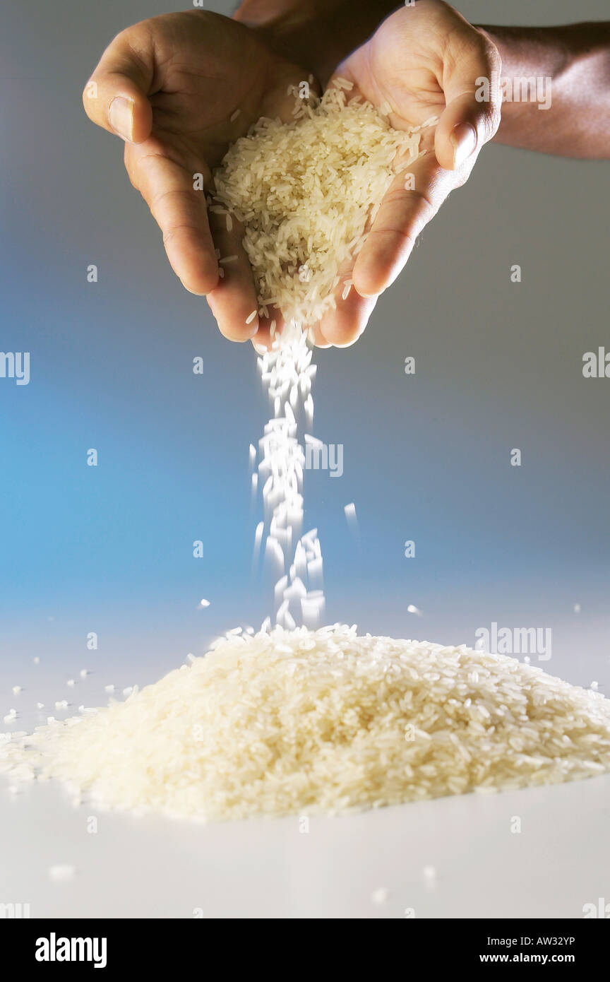 A Handful of Uncooked Rice Stock Photo - Alamy