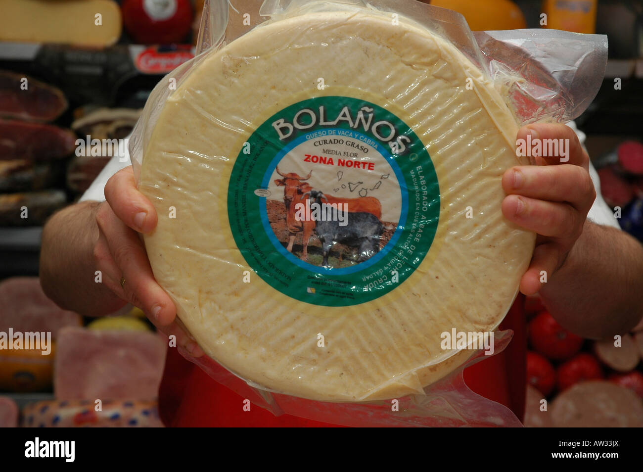 A vendor holds a wheel of Queso de Flor, Goat cheese produced at the ...