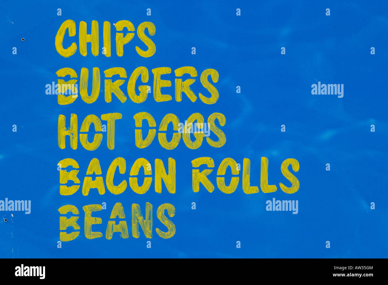 Unhealthy menu stencilled on the side of a beach cafe Stock Photo - Alamy