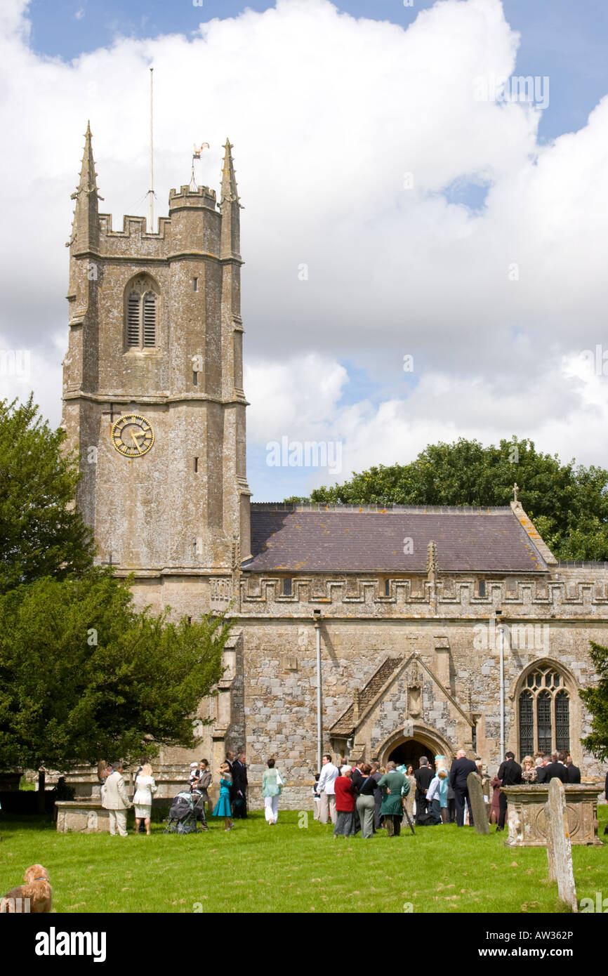 Wedding guests congregate outside the church in Avebury Stock Photo - Alamy