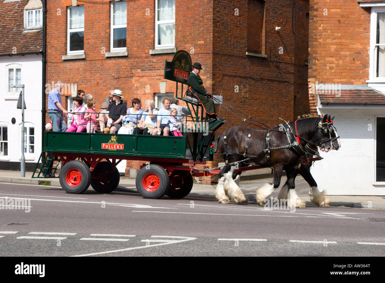 A pair of shire horses pulling a Fullers Brewery cart giving rides to ...