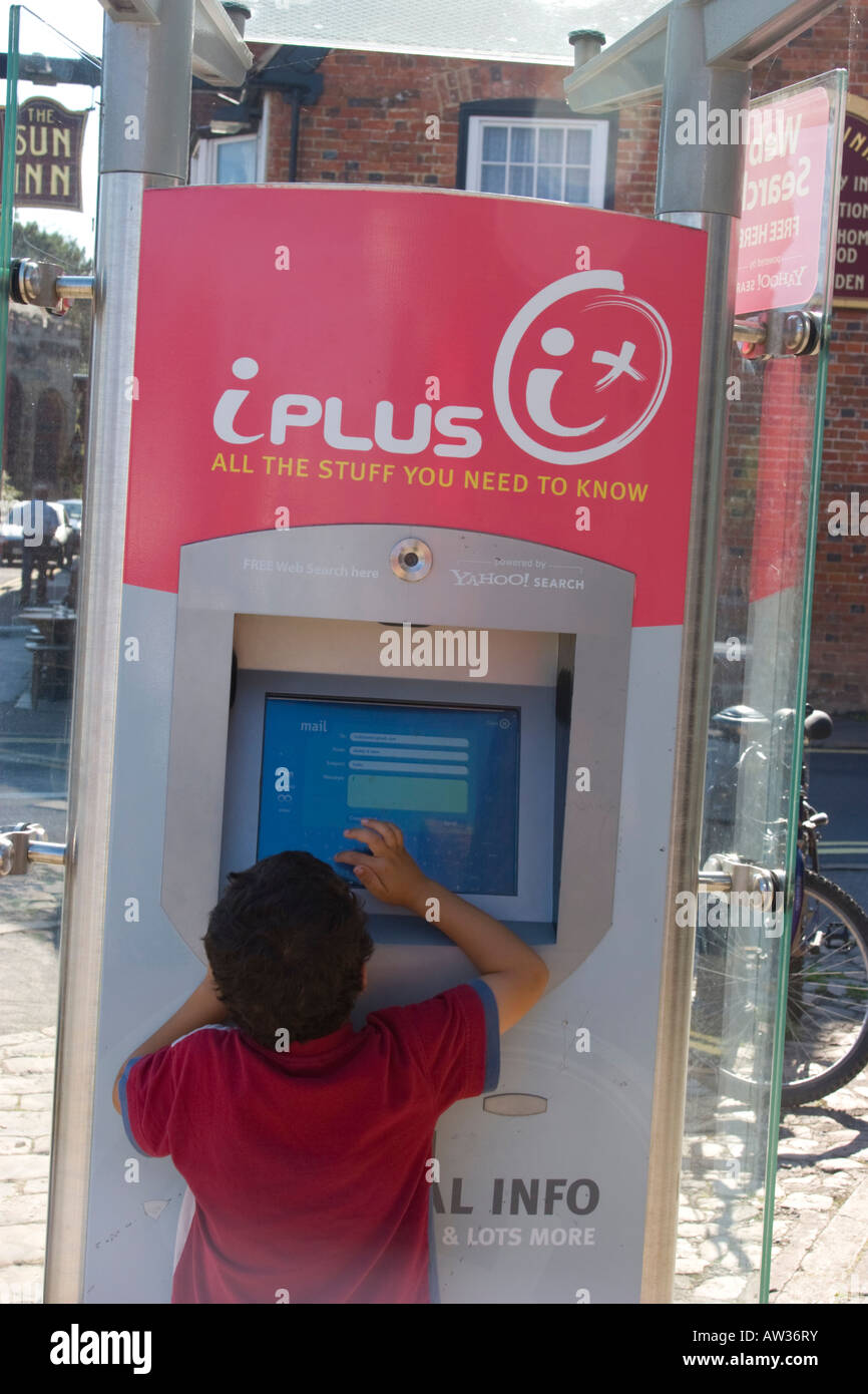 Small boy using iPlus terminal to access email and internet from the ...