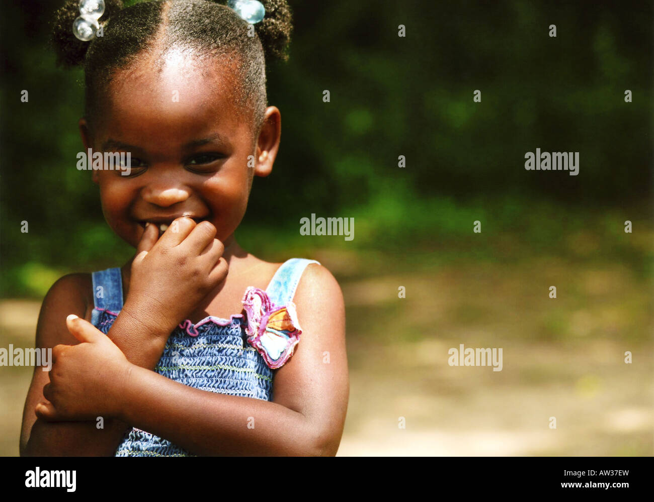 Little girl being shy in front of the camera Stock Photo - Alamy