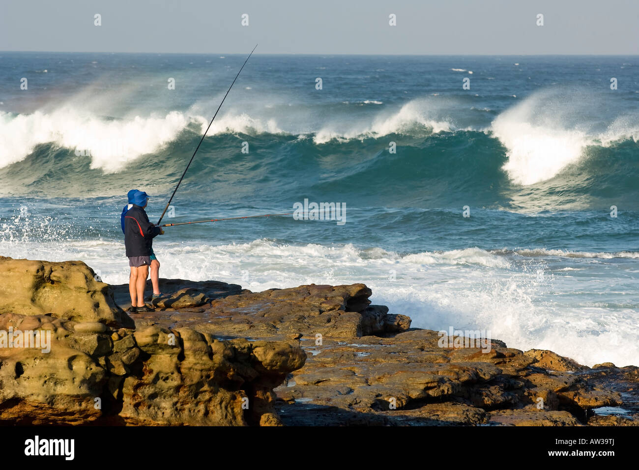 Fishing from the rocks Uvongo beach South Africa Stock Photo - Alamy