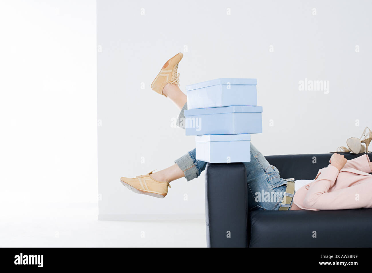 Woman on sofa shoe boxes hi-res stock photography and images - Alamy
