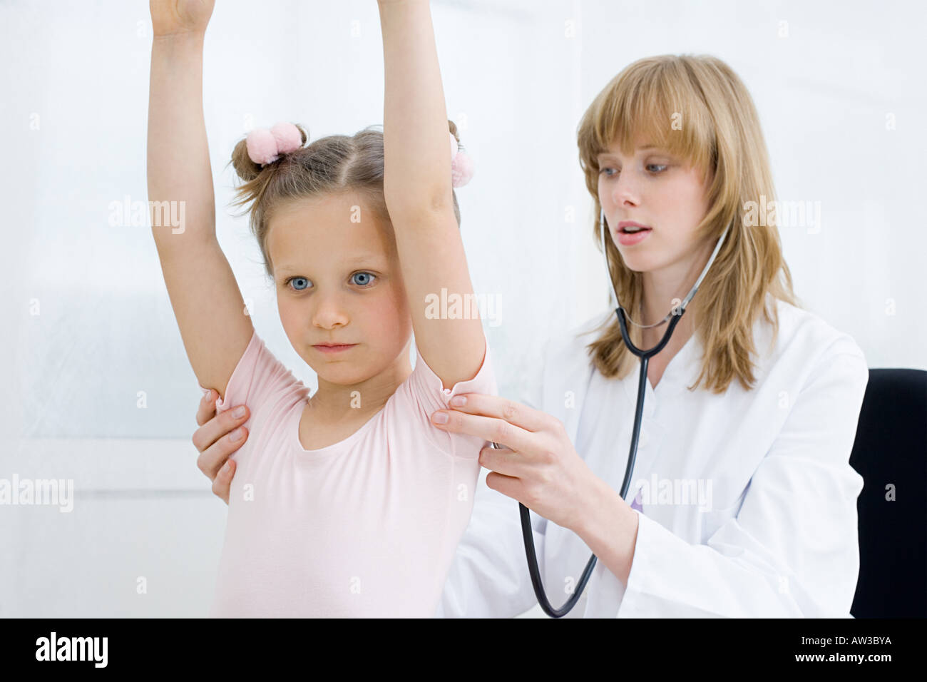 Girl having a check up with doctor Stock Photo - Alamy