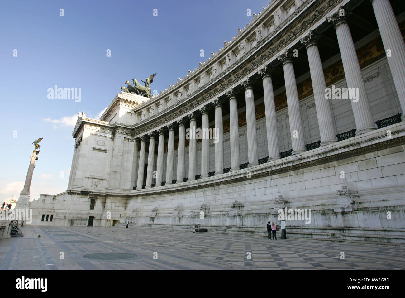 Tourists are dwarfed by massive white stone columns at the famous ...
