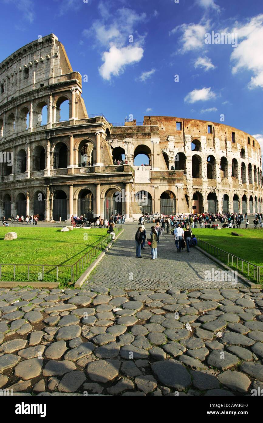Tourists and cobbled paths in front Colosseum in Rome, a popular ...
