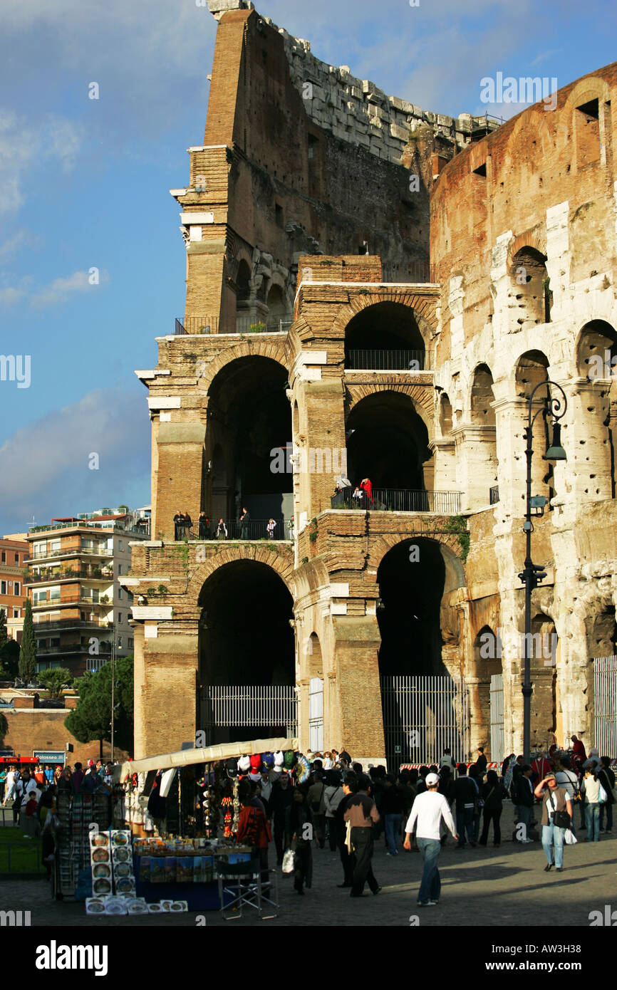 Tourists crowd the entrance to the famous Colosseum monument and browse ...